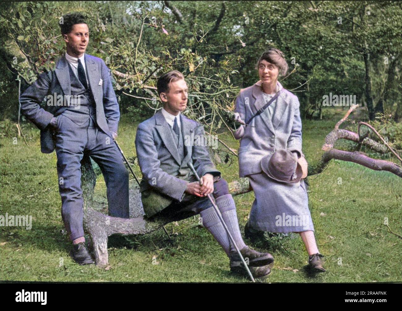 Three people -- two men and a woman -- posing for their photo with a ...