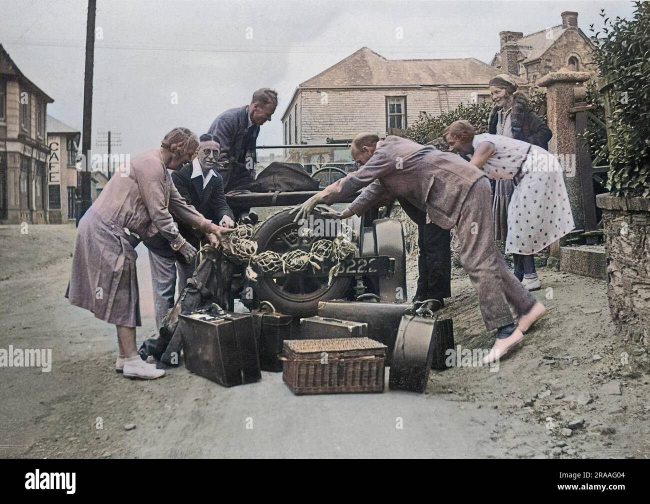 People loading a car at Perranporth, Cornwall. Date: 1931 Stock Photo ...