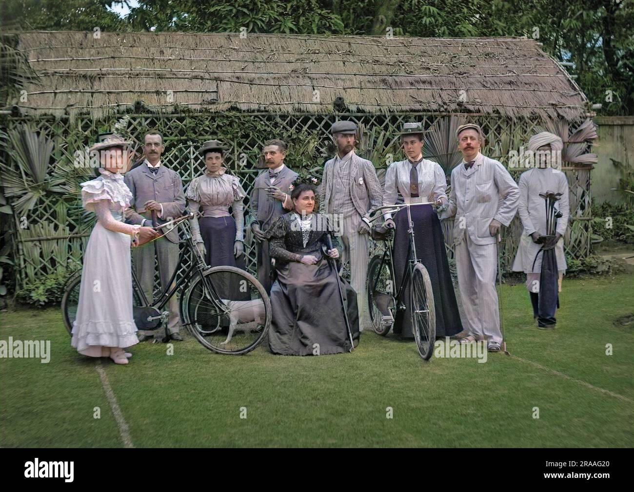 A group of eight colonial types, four men and four women. An Indian ...