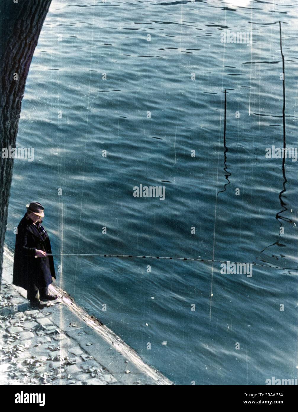 A lone angler on the Bank of the Seine, Paris Date: 1930s Stock Photo ...