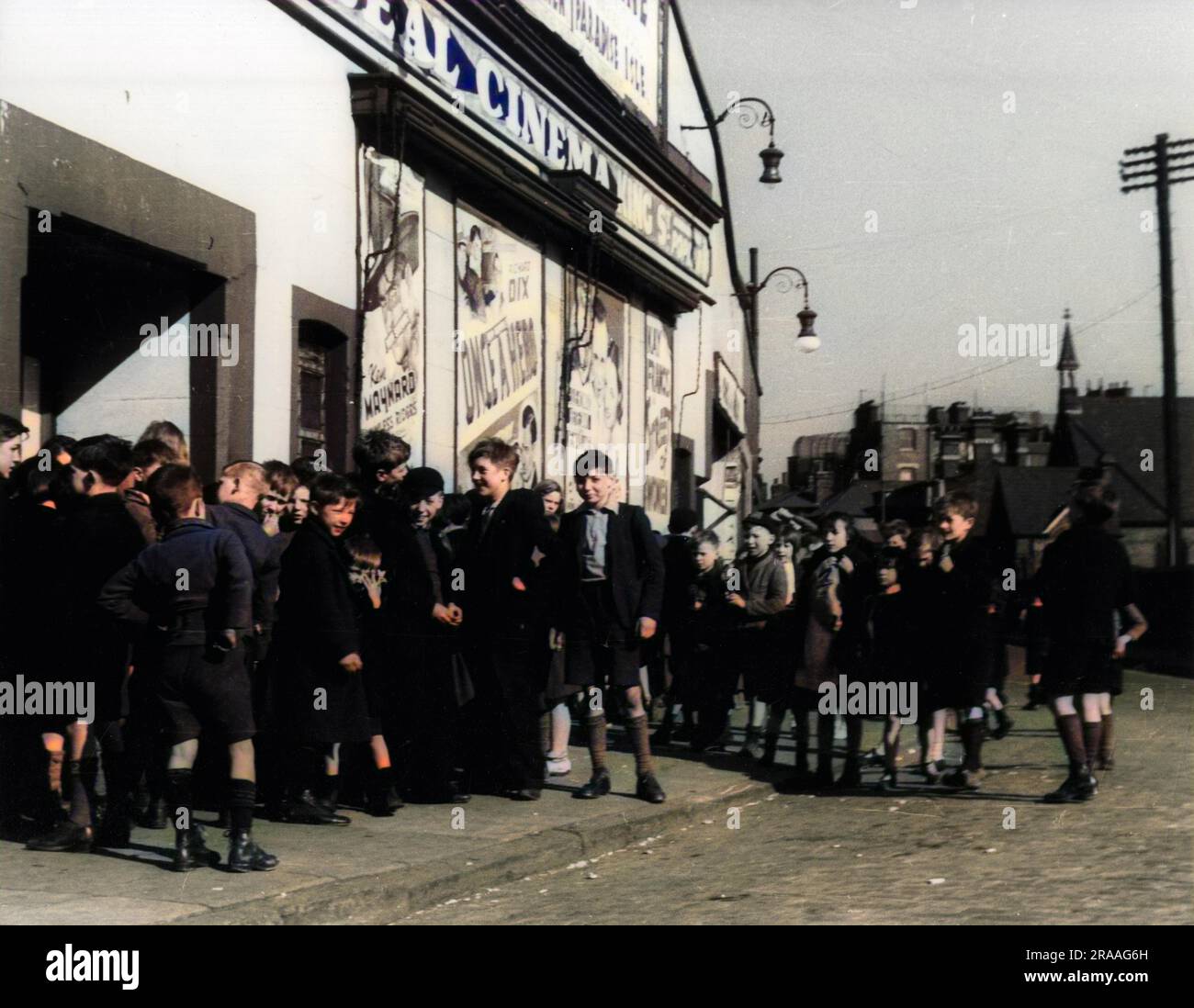 Children waiting to go into the Ideal cinema, King Street, Poplar ...