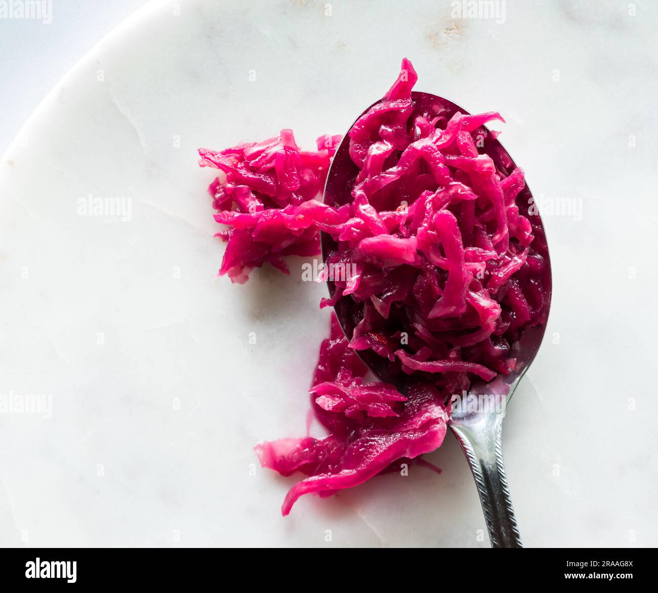 Bright pink beet and cabbage sauerkraut on a large spoon Stock Photo ...