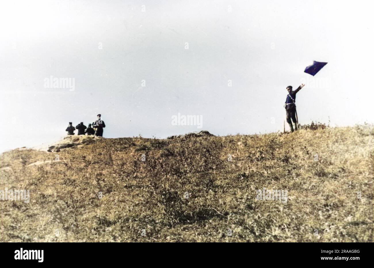 A lone Russian soldier atop a hill using Semaphore flags to communicate ...