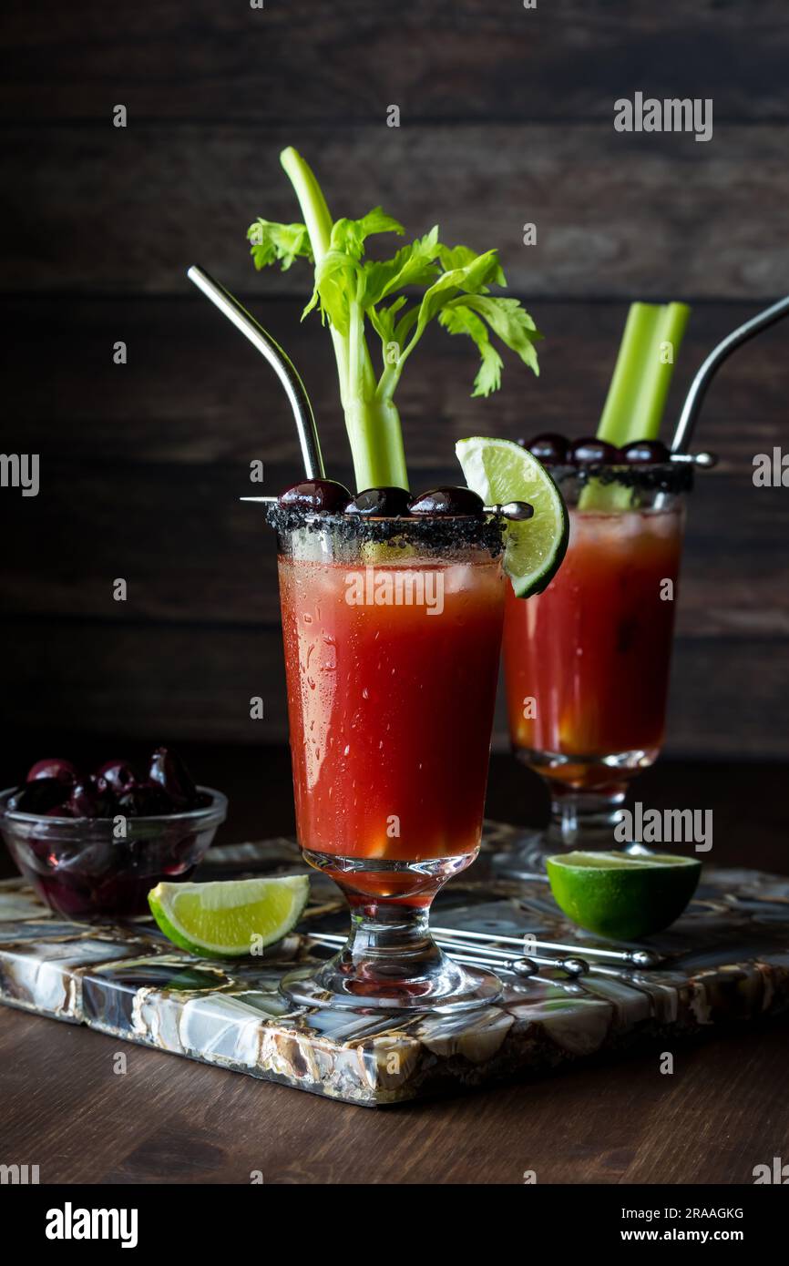 Refreshing Caesar cocktails, ready for drinking, against a dark ...