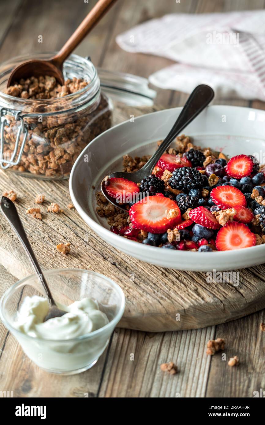 A healthy breakfast bowl with granola clusters and berries with greek ...
