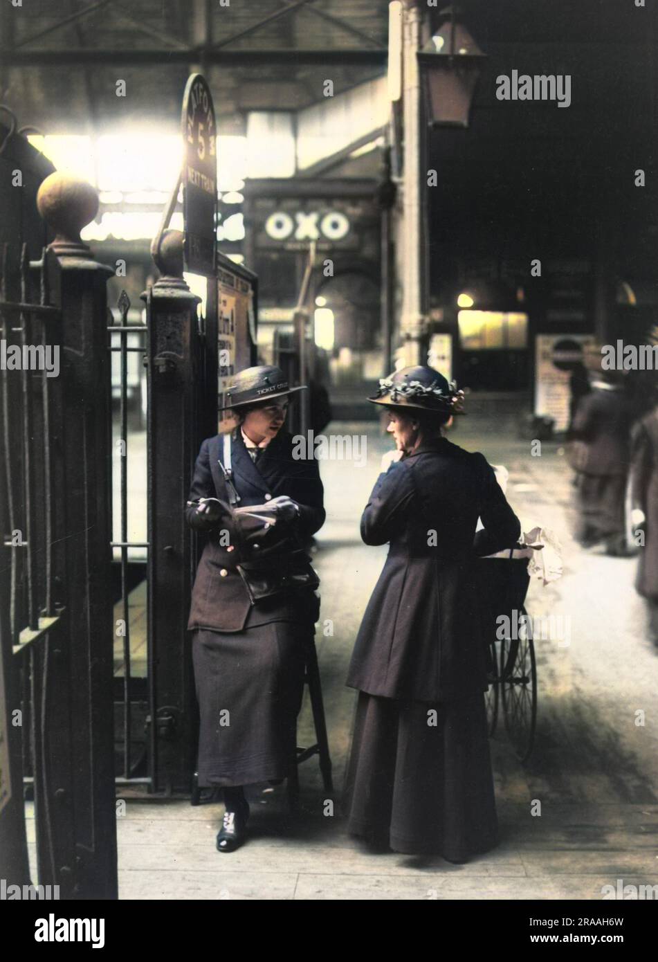 A female ticket collector at platform five in a London train station ...