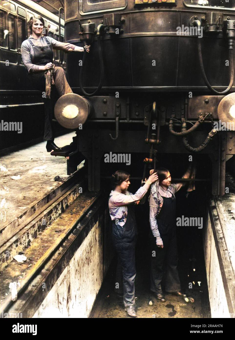 Three women working on a train carriage. London depot Stock Photo - Alamy