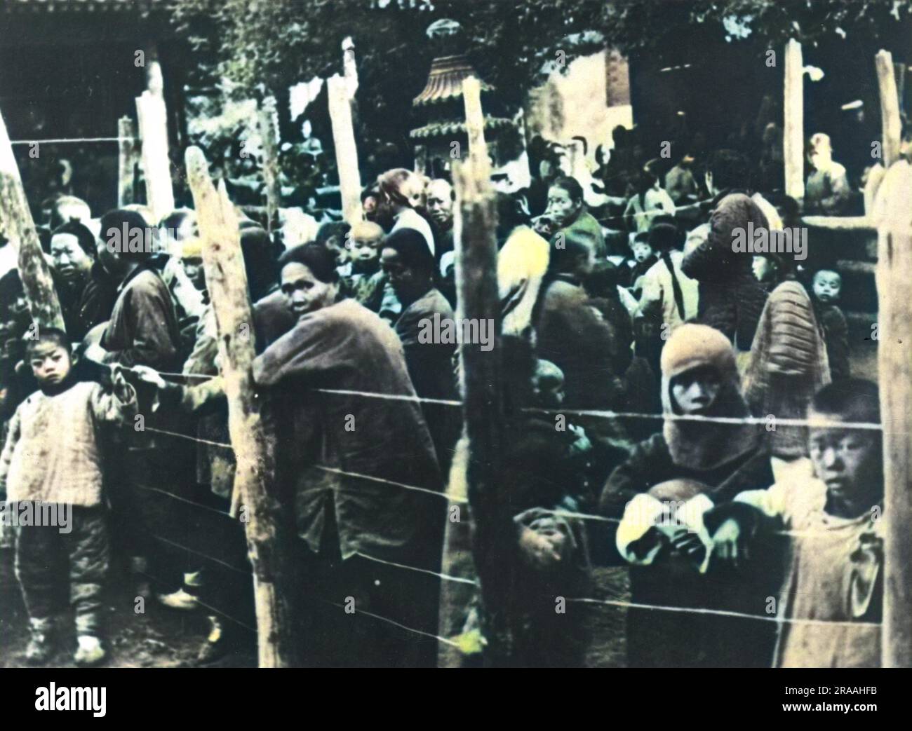 Chinese refugees gather together following the bombardment of Beijing ...