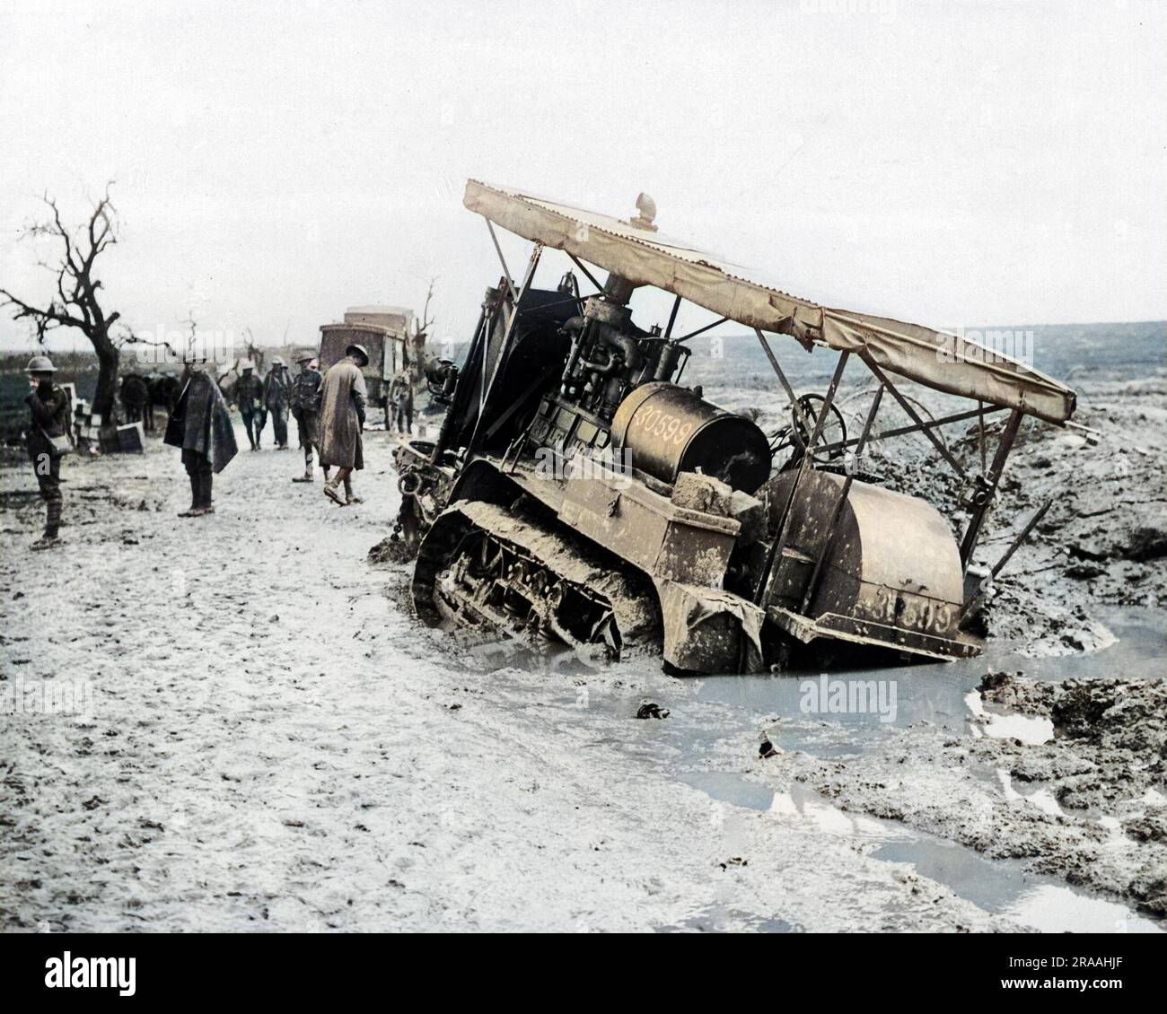 British soldiers with a vehicle stuck in the mud on a road after heavy ...