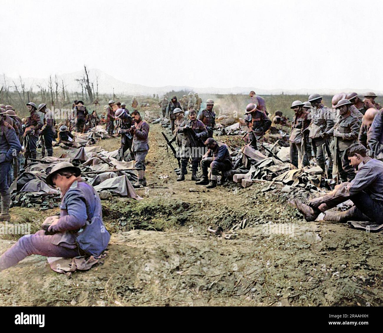 British troops resting and cleaning their weapons on their way back from the line on the Western ...