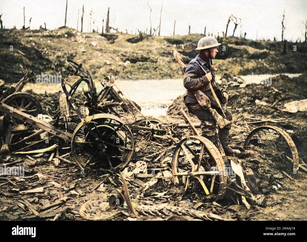 A British soldier waiting by some old farm machinery on the Western ...