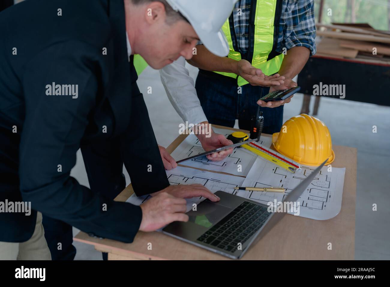 multi ethnic engineer brainstorming and measuring for cost estimating ...