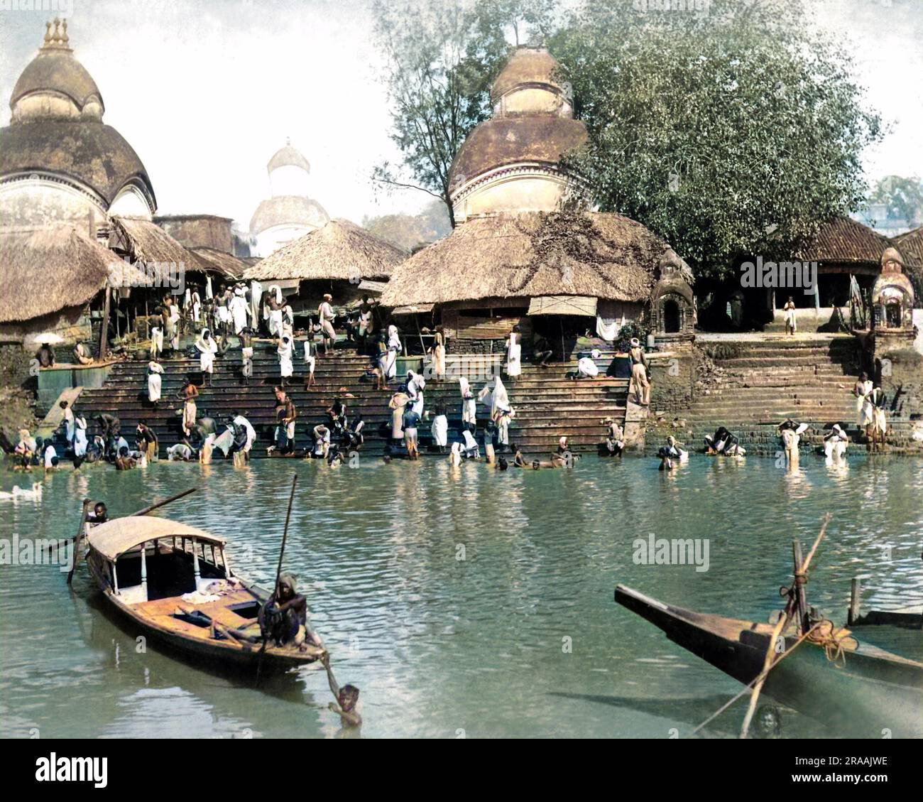People at a bathing ghat, India. A ghat is a series of steps leading ...