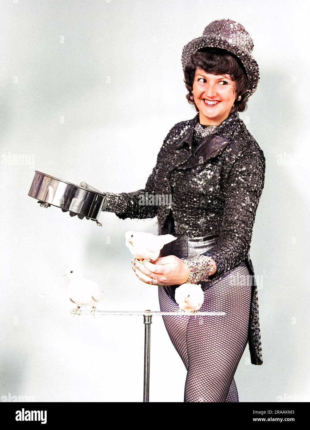 Magician with three white doves. Date: circa 1980s Stock Photo - Alamy