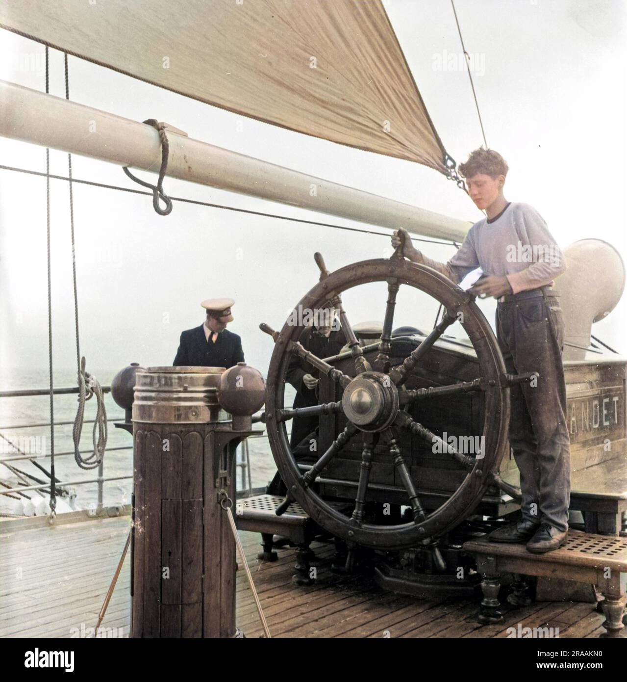 Two men and a boy on the deck of the Sorlandet, a Norwegian tall ship ...