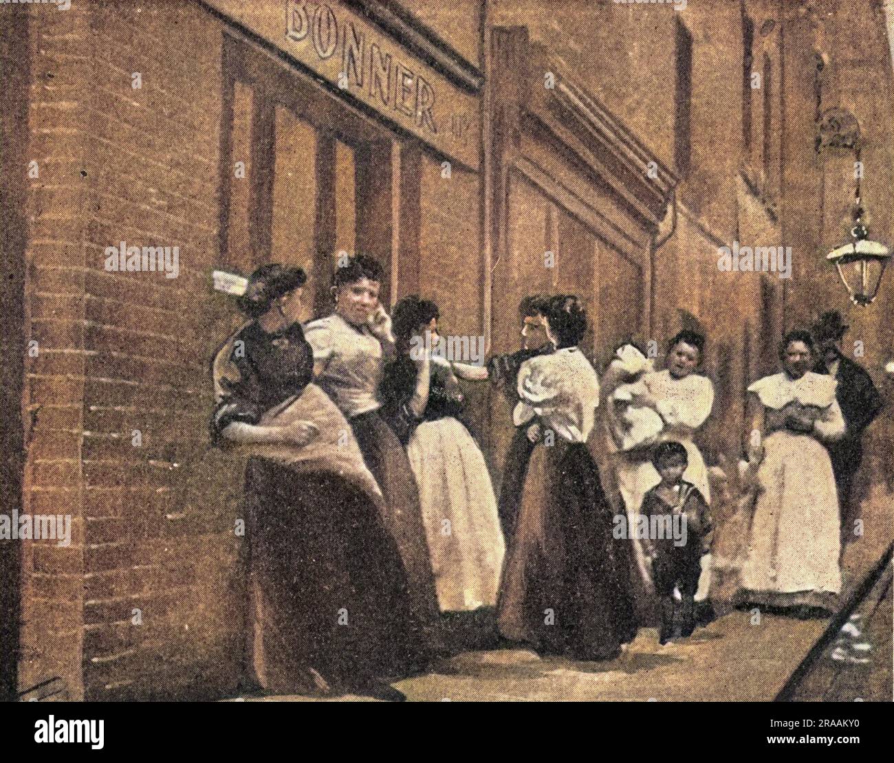 An informal 'women's club', some with children, gather outside a public ...