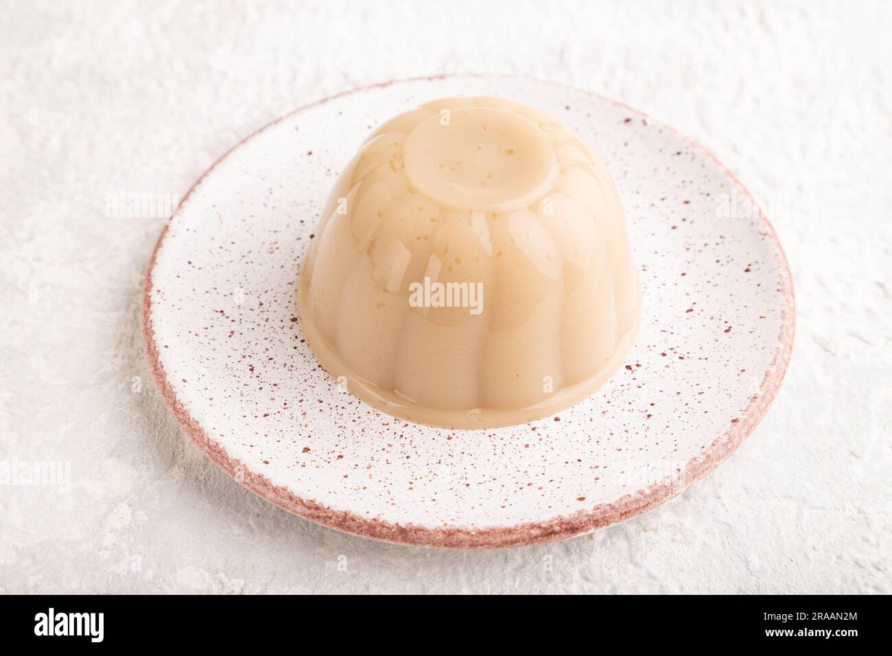 Buckwheat milk jelly on gray concrete background. side view, close up ...