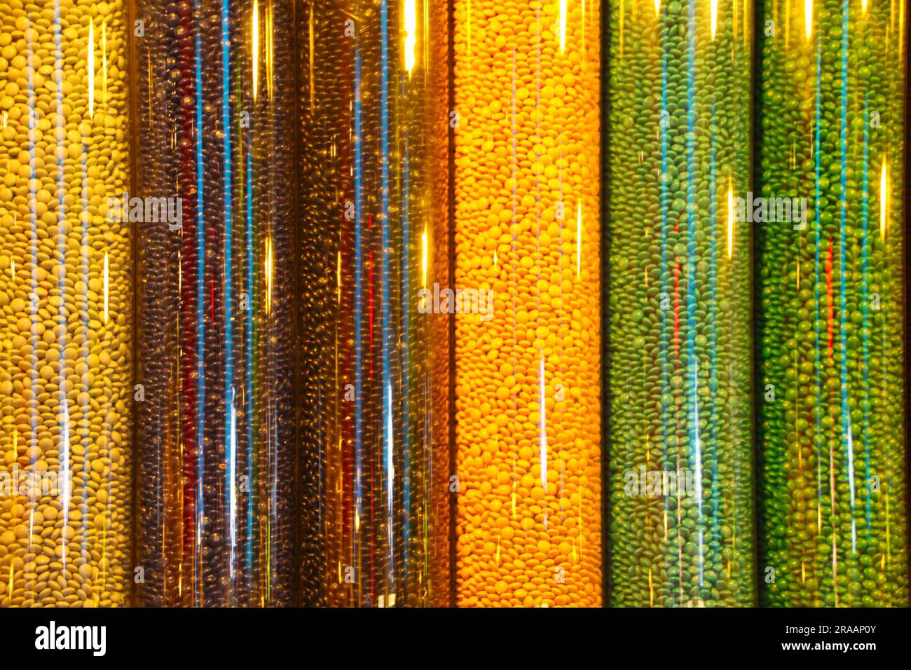 Colorful candies inside shiny cylindrical containers Stock Photo - Alamy
