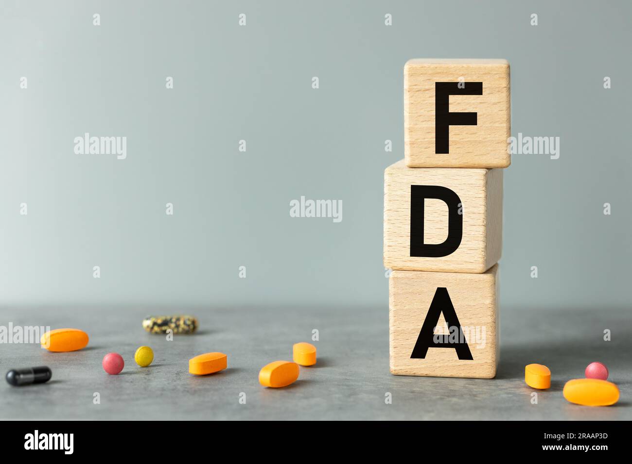 FDA, words on wooden blocks. Beautiful gray background, business ...
