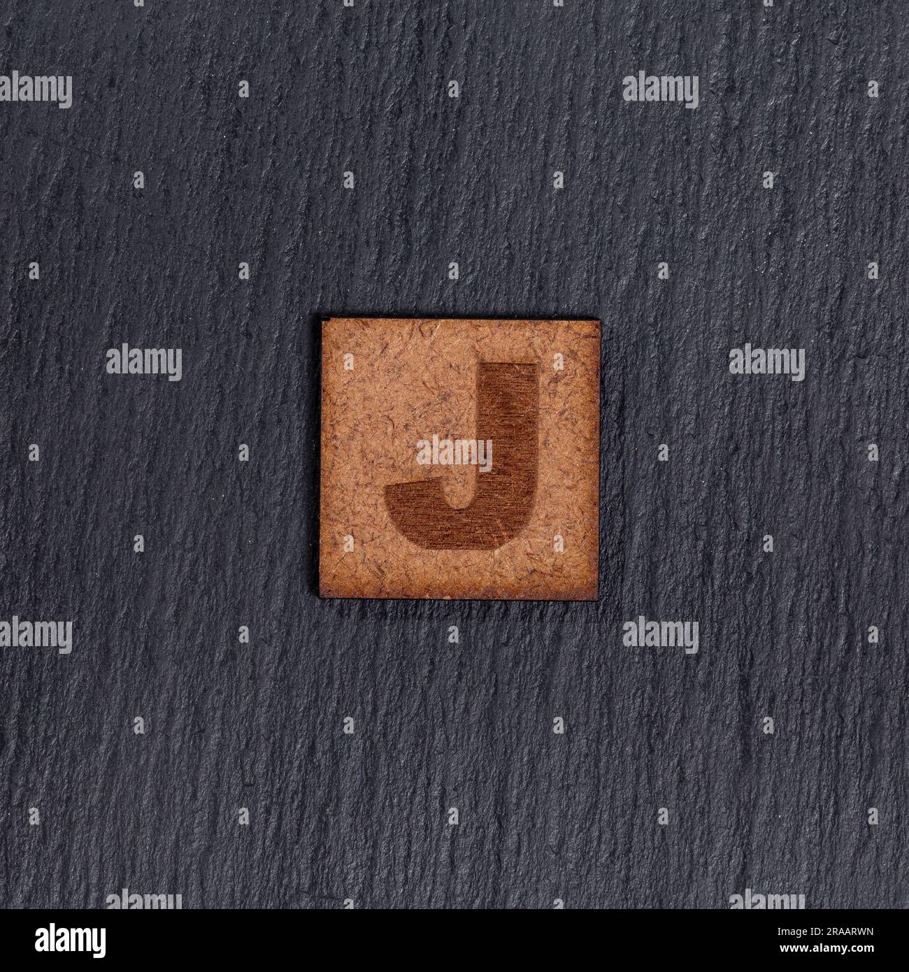 Capital Letter In Square Wooden Tiles - Letter J, On Black Stone ...