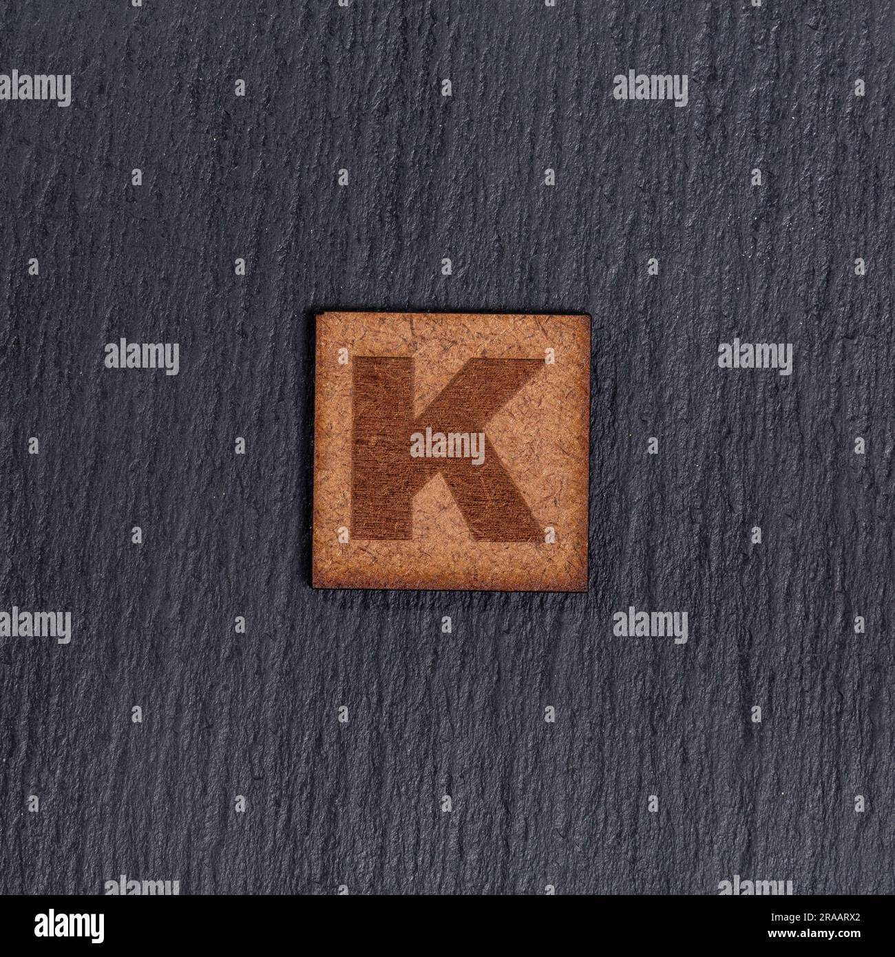 Capital Letter In Square Wooden Tiles - Letter K, On Black Stone ...