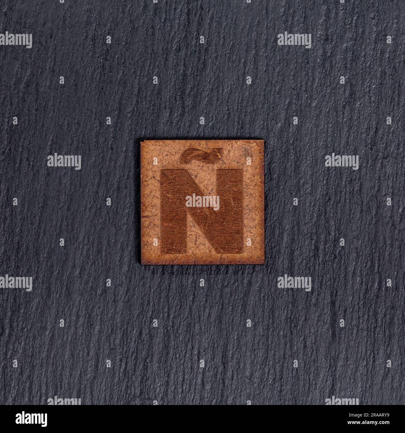 Capital Letter In Square Wooden Tiles - Letter N, On Black Stone ...