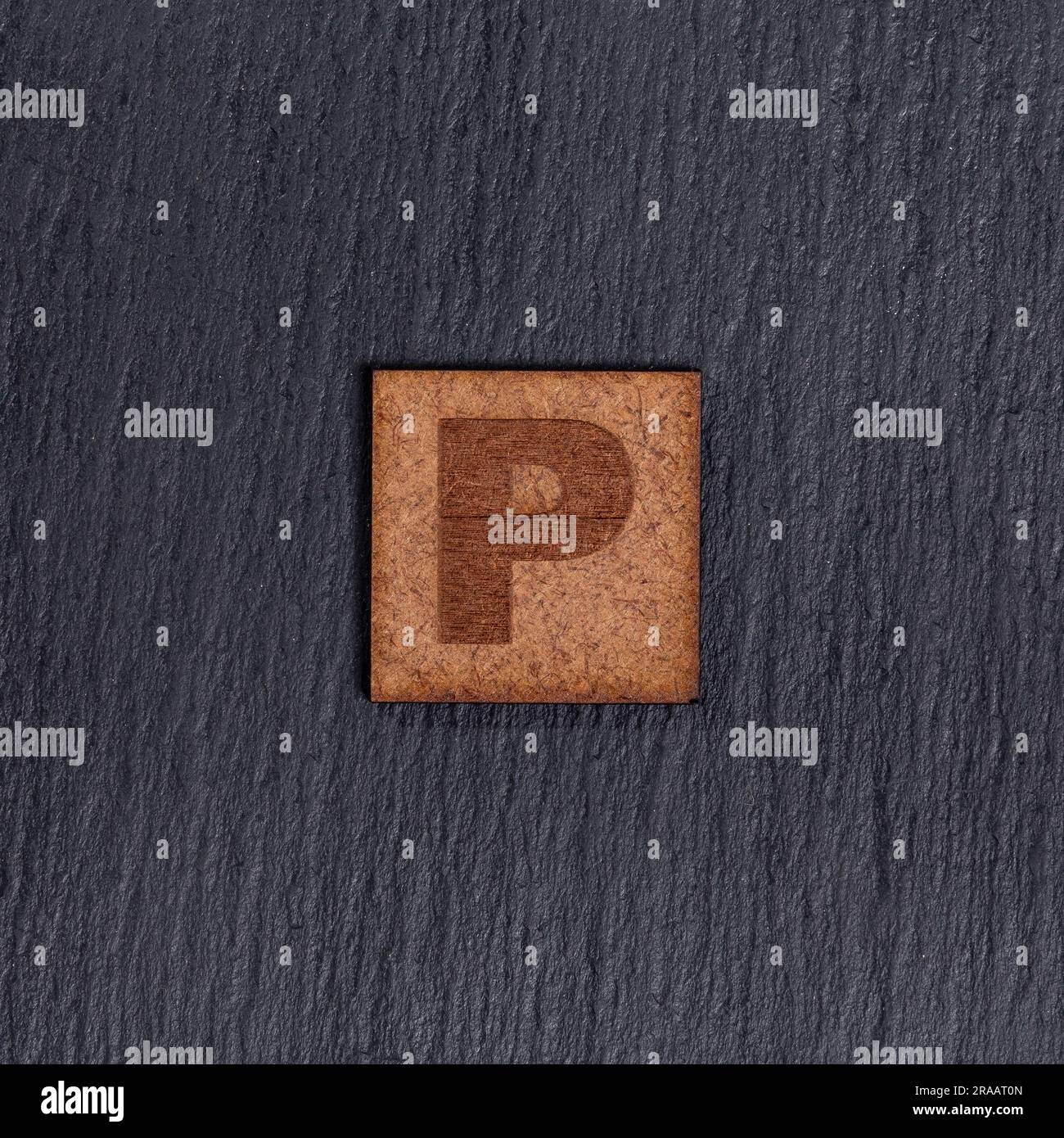 Capital Letter In Square Wooden Tiles - Letter P, On Black Stone ...