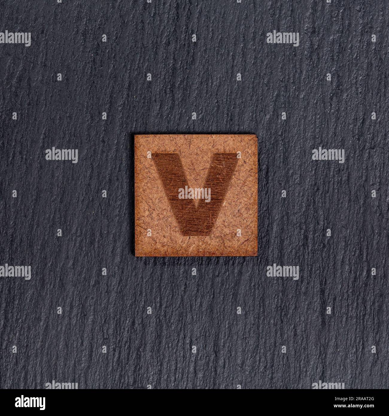 Capital Letter In Square Wooden Tiles - Letter V, On Black Stone ...