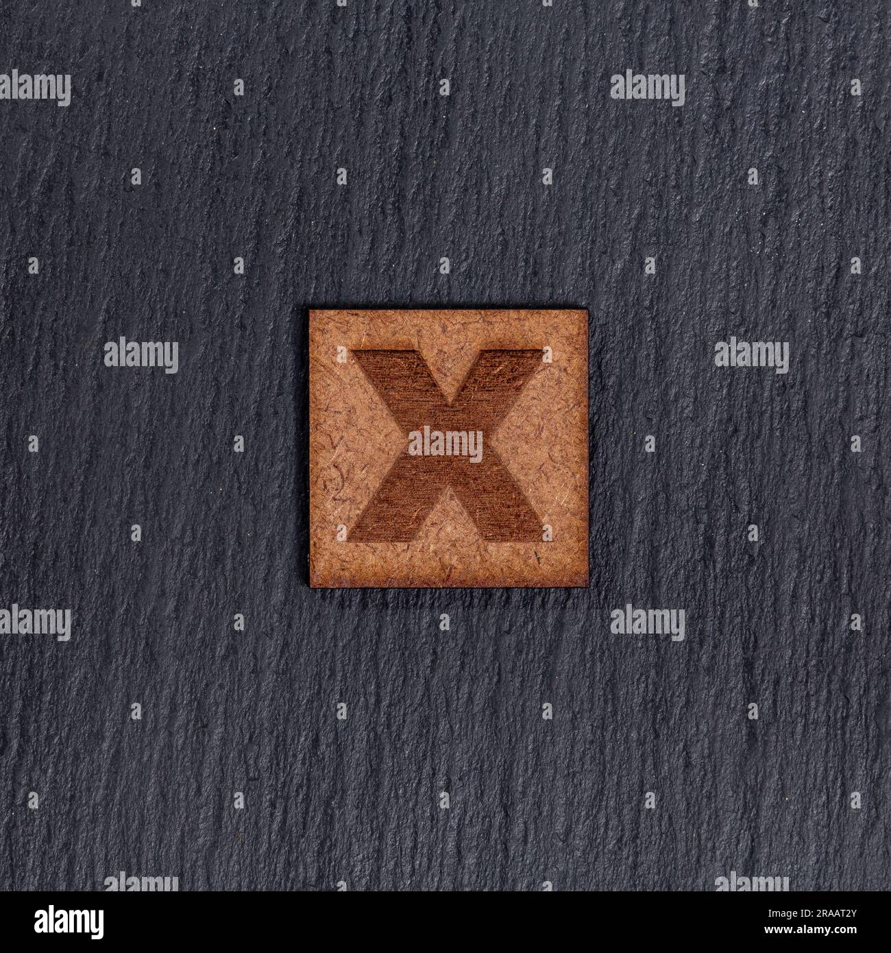 Capital Letter In Square Wooden Tiles - Letter X, On Black Stone ...