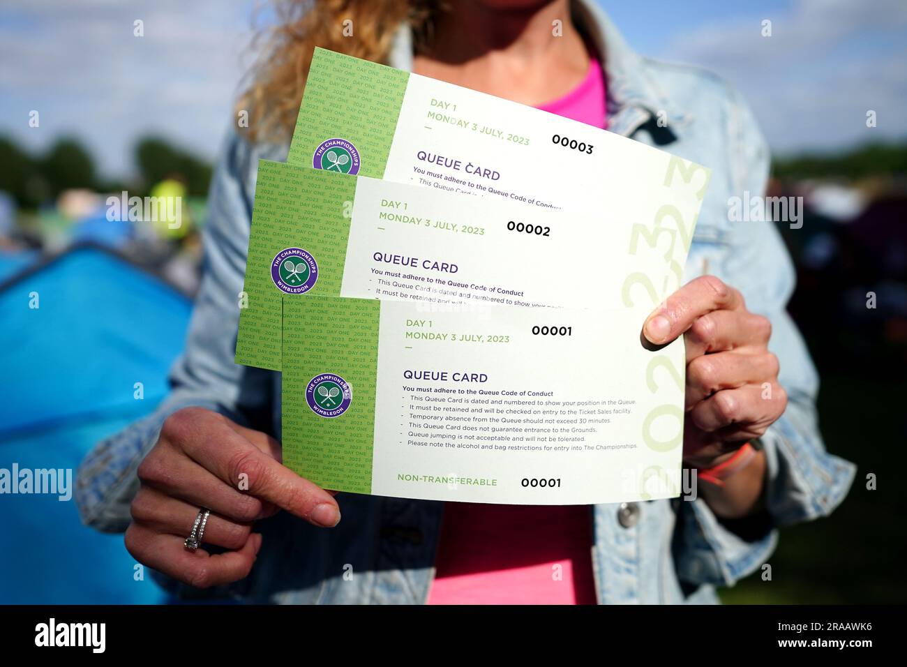 Julia Barker hold up tickets showing her, along with her husband Nicky ...