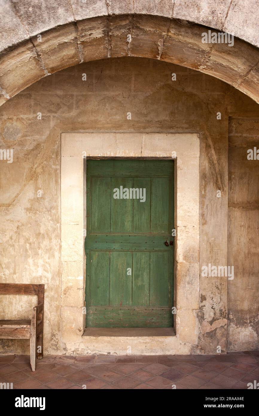 Arch and door in the cloister of an old abbey in the South of France ...