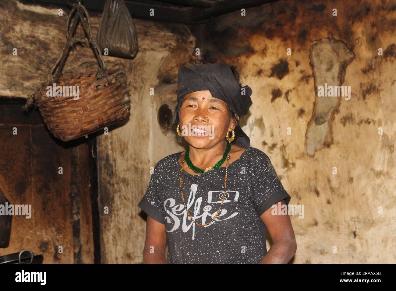 A Nepali Limbuni Mother in her traditional Nepalese Home in Taplejung, Nepal Stock Photo - Alamy