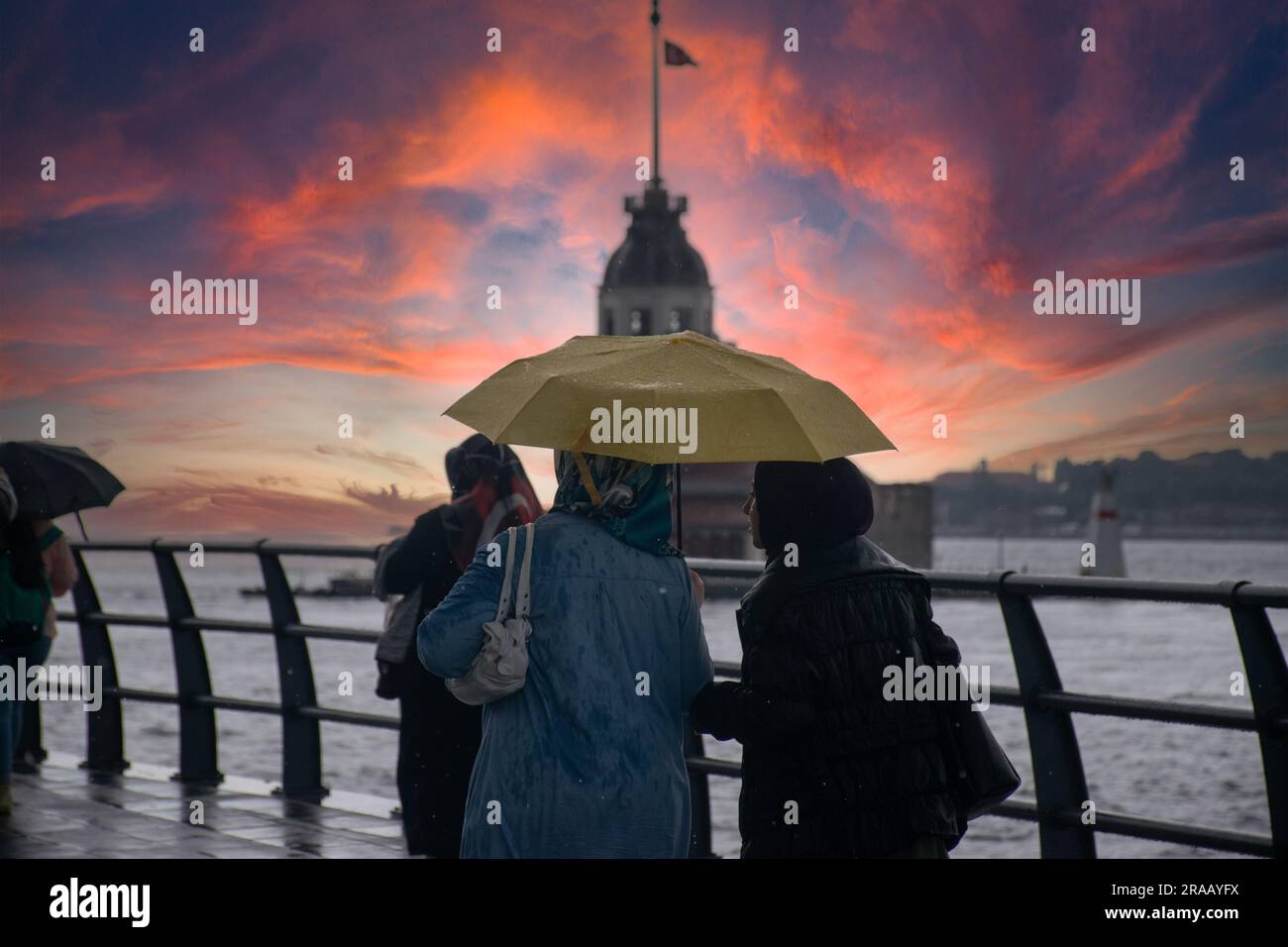 Womens walking in the rain and the famous maiden's tower in the ...