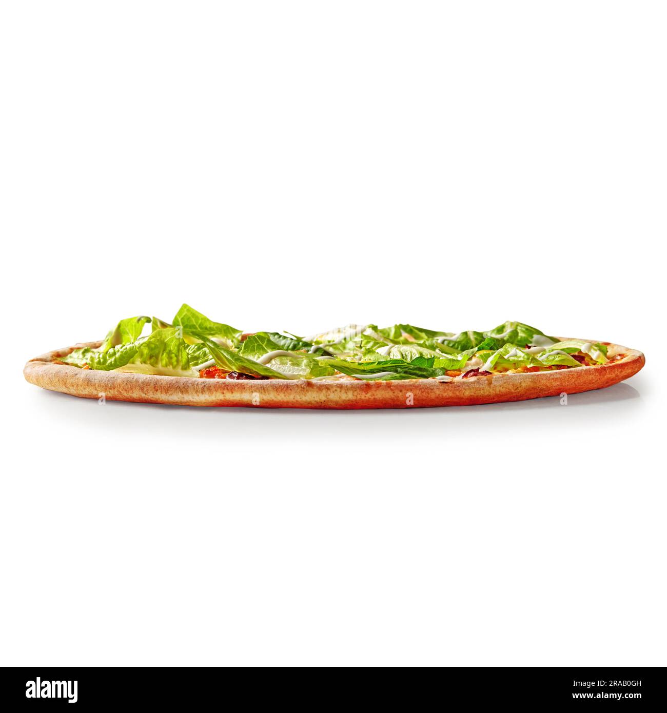 Thin pizza with browned edge topped with lettuce and cream cheese sauce ...