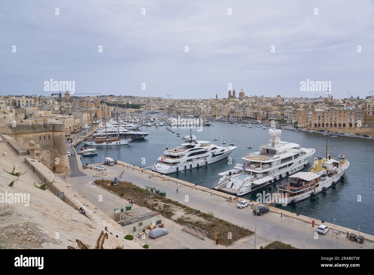 Luxury boats moored alongside Fort Saint Angelo in Grand Harbour ...
