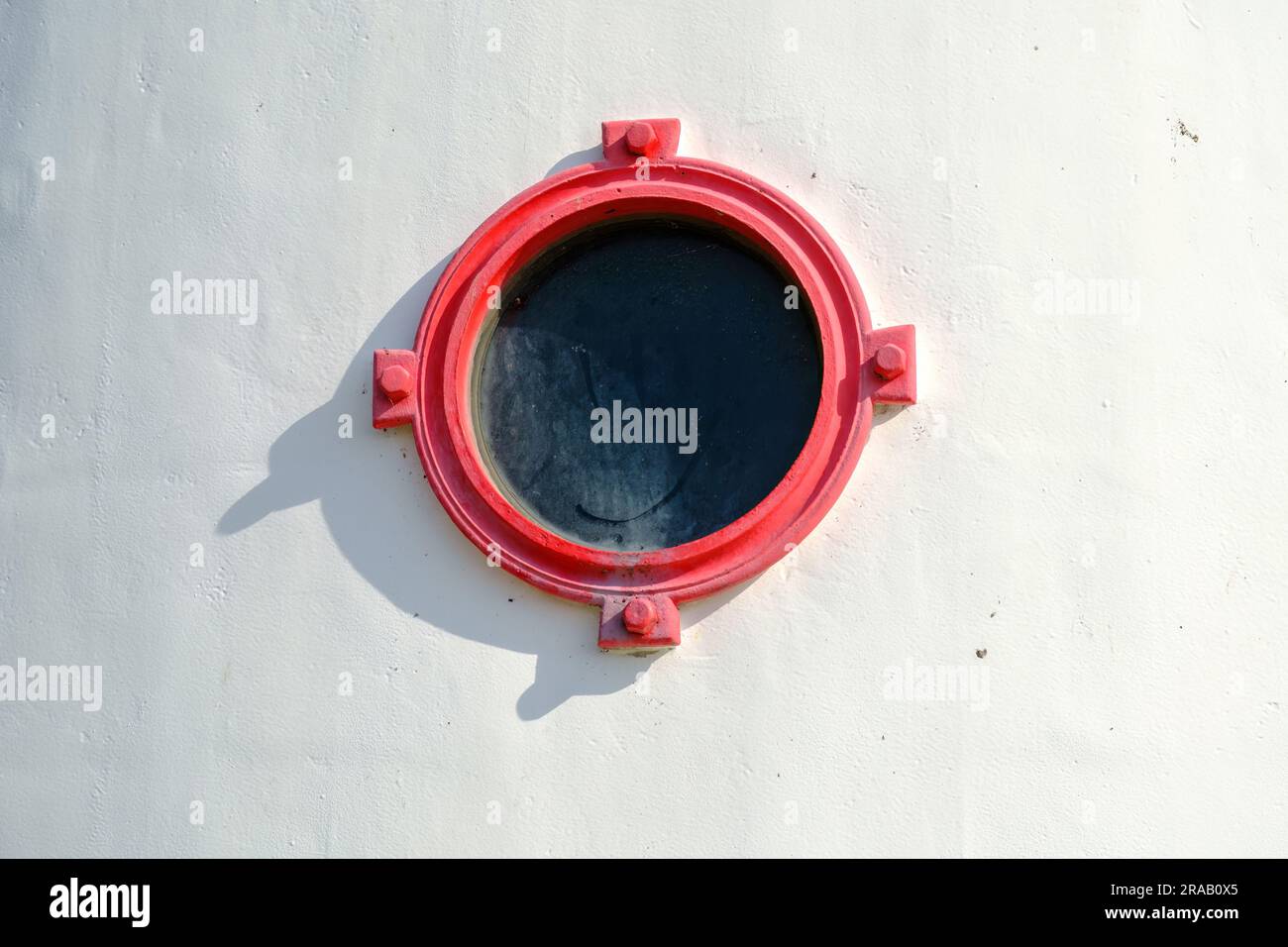 A round window with red edges. Lighthouse on the Estonian island of ...