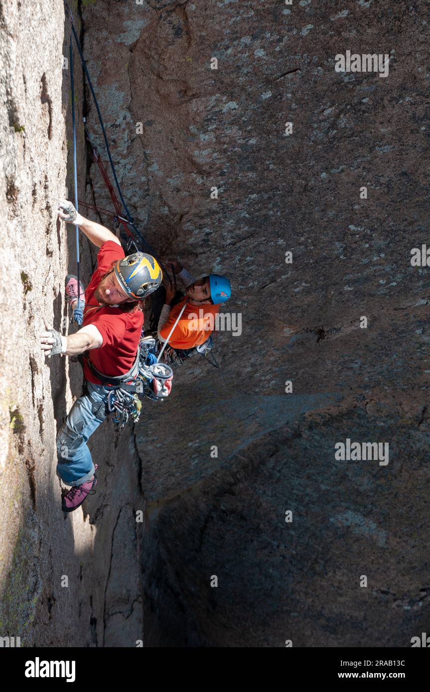 Male rock climber ascends a steep rock face in the Dragoon Mountains ...