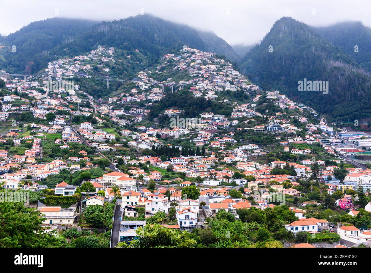 Houses built on the side of volcanic mountains, Funchal, Madeira Stock ...