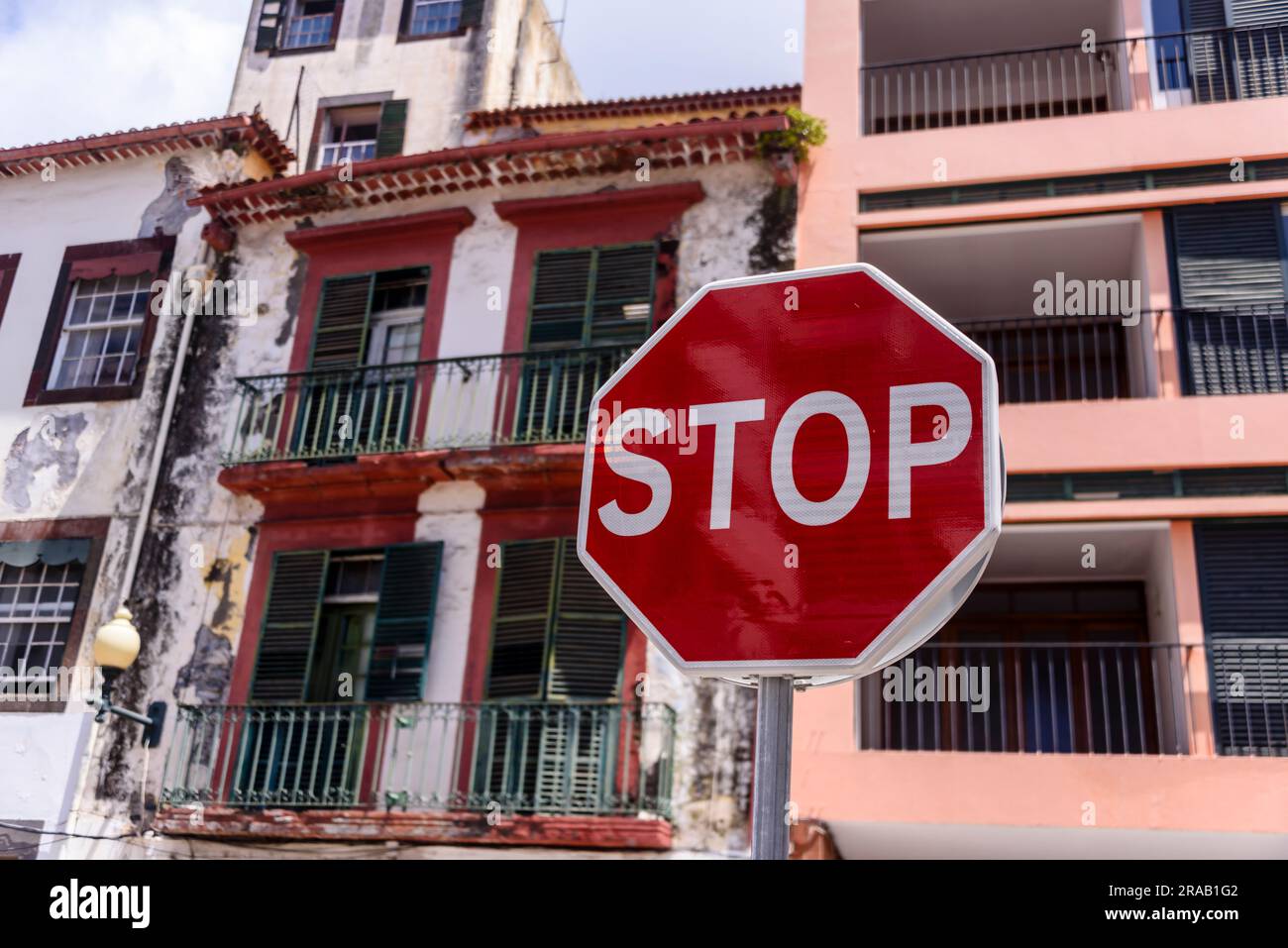 Stop sign in front of some old European buildings Stock Photo - Alamy