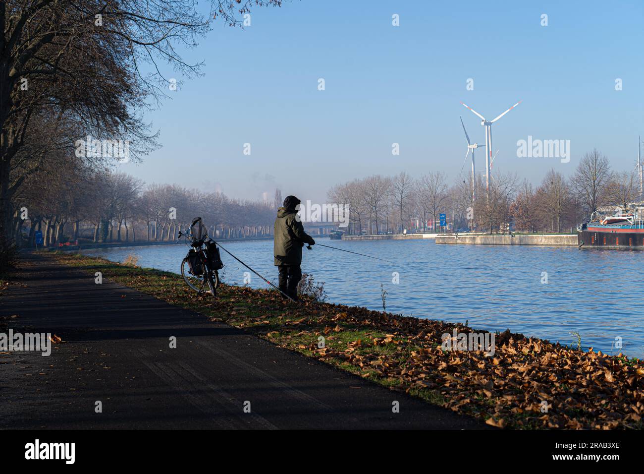 Fishing in winter. Fishsport in Belgium canal Roeselare Leie. Enjoy ...