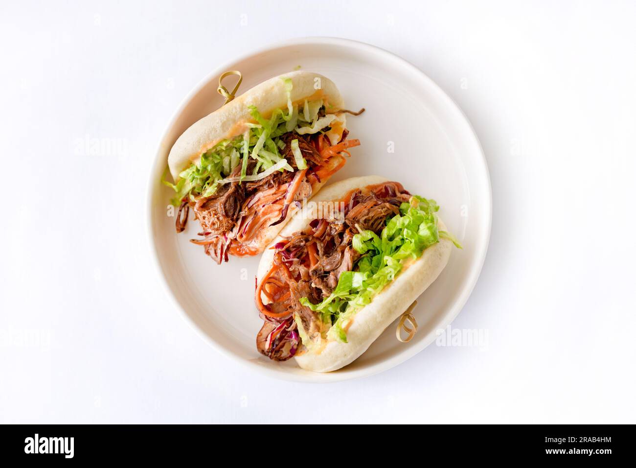 Steamed buns Bao with pulled beef and iceberg lettuce Stock Photo - Alamy