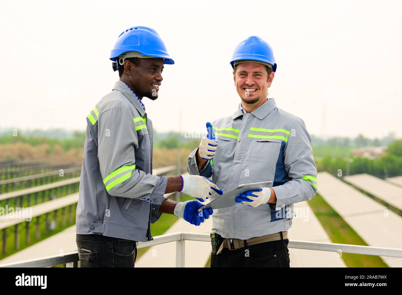 Happy maintenance engineers checking and maintaining solar panels Stock ...