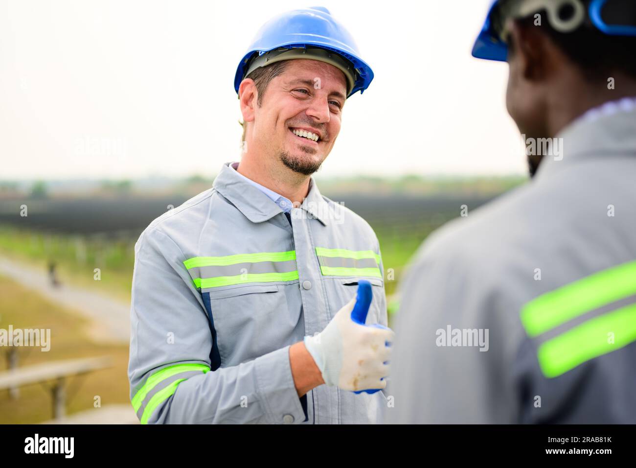 Happy maintenance engineers checking and maintaining solar panels Stock ...