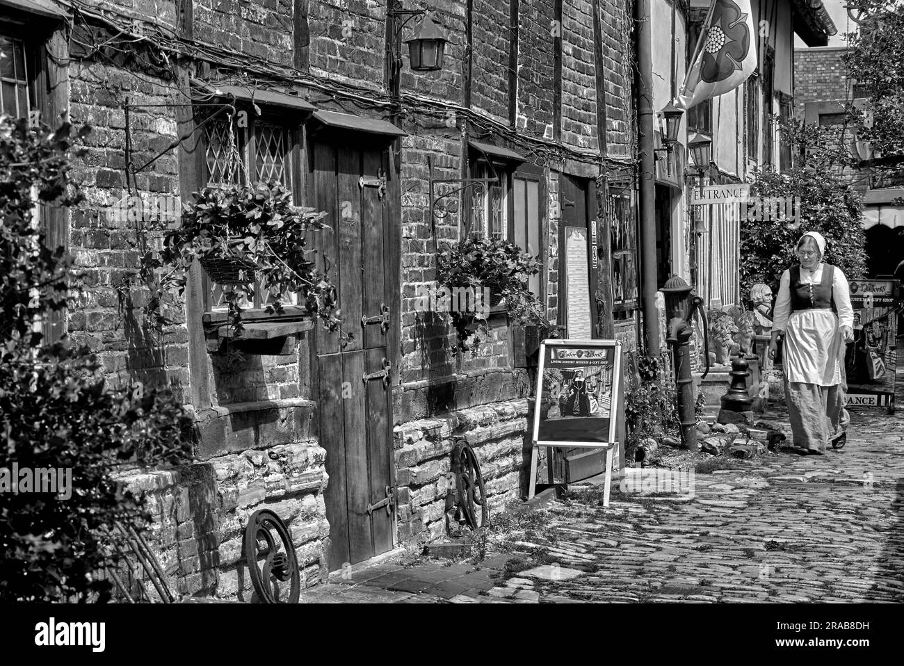 Tudor World museum entrance.16th century cobblestone alleyway and half ...