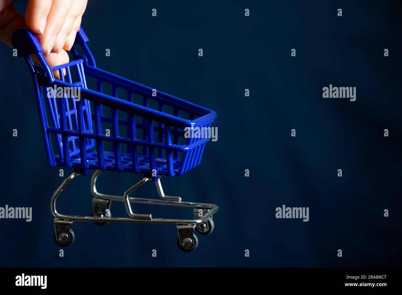 supermarket trolley blue and hand on a isolated background Stock Photo ...