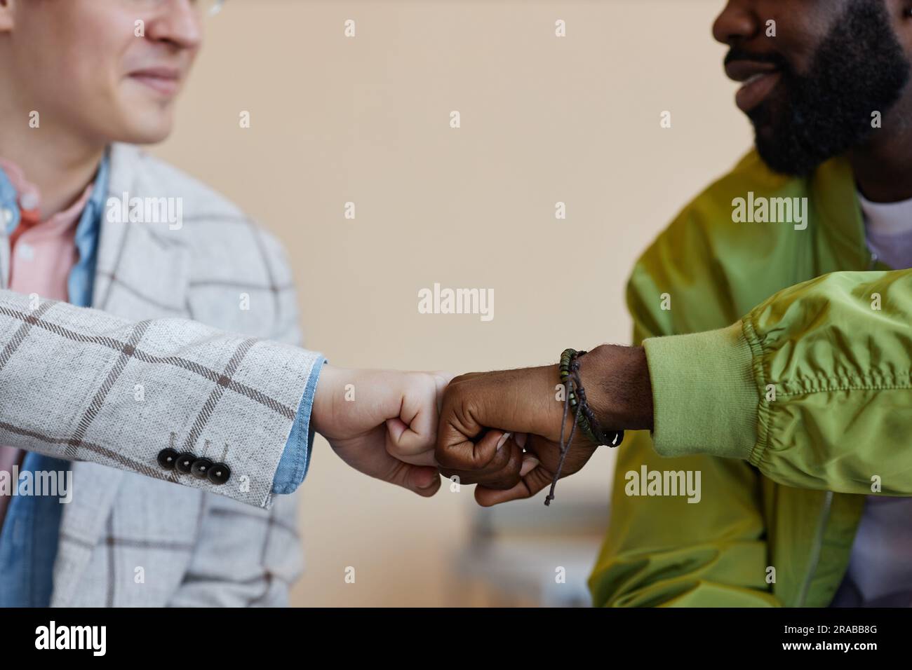 Close-up of young men greeting each other at psychotherapy session ...