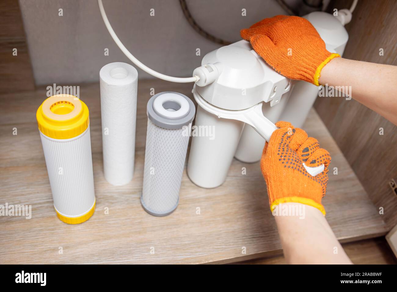 Plumber installs change water filter hi-res stock photography and ...