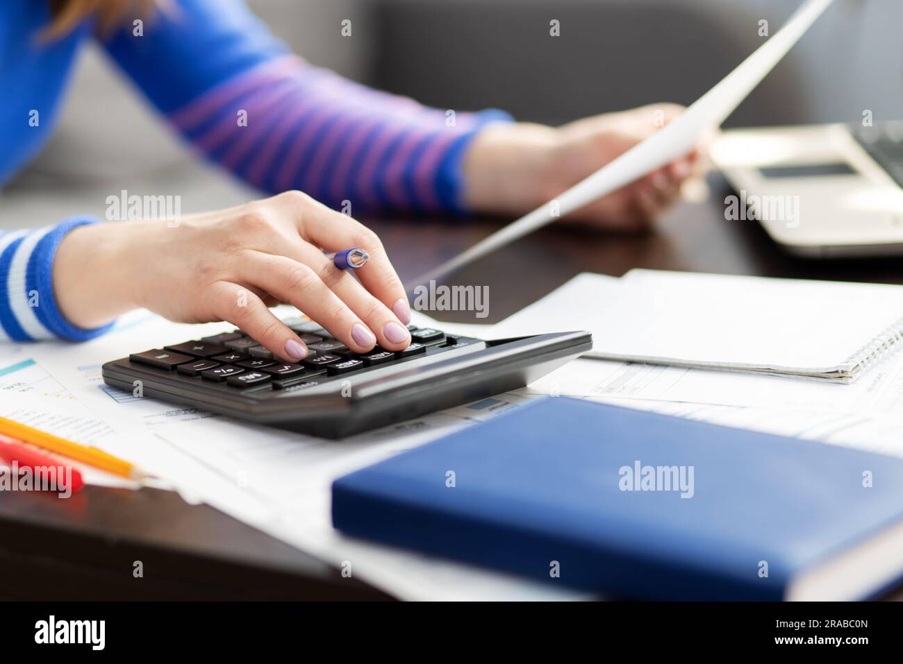 Woman using calculator for calculate domestic bills at home, doing ...
