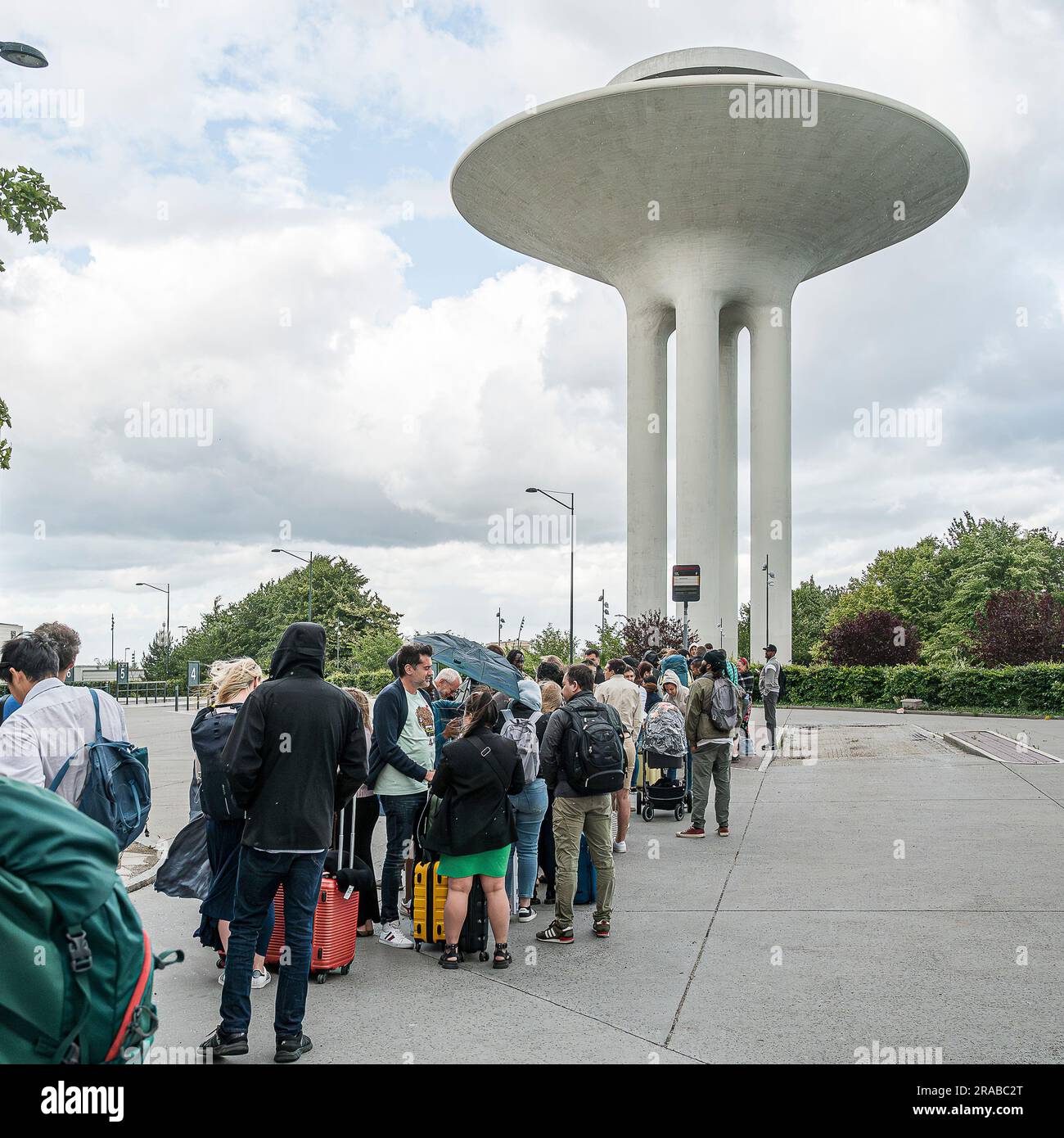 passengers waiting in a long queue for a replacement bus across the ...