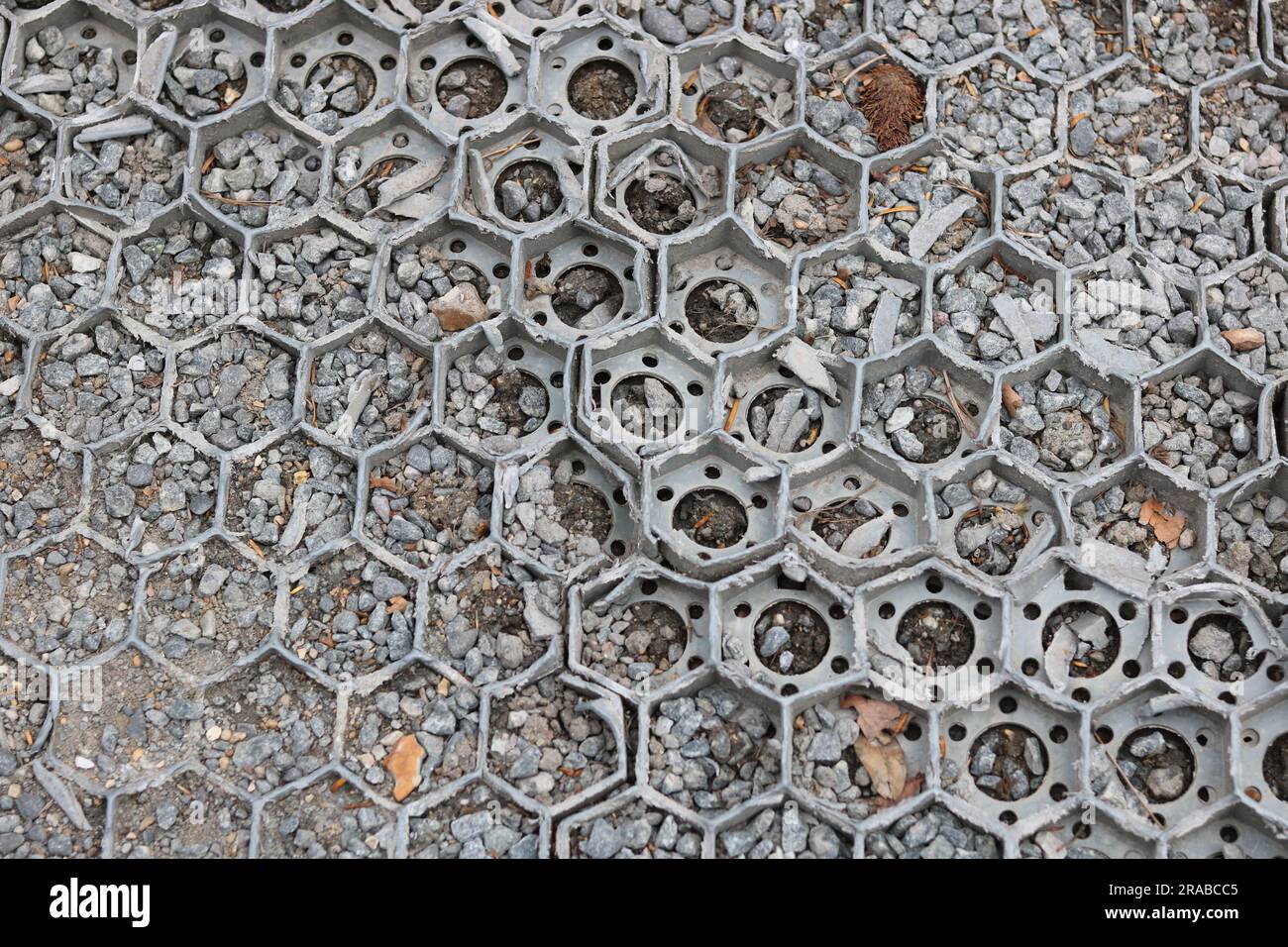 Plastic and gravel hardstanding over grass with hexagonal design ...